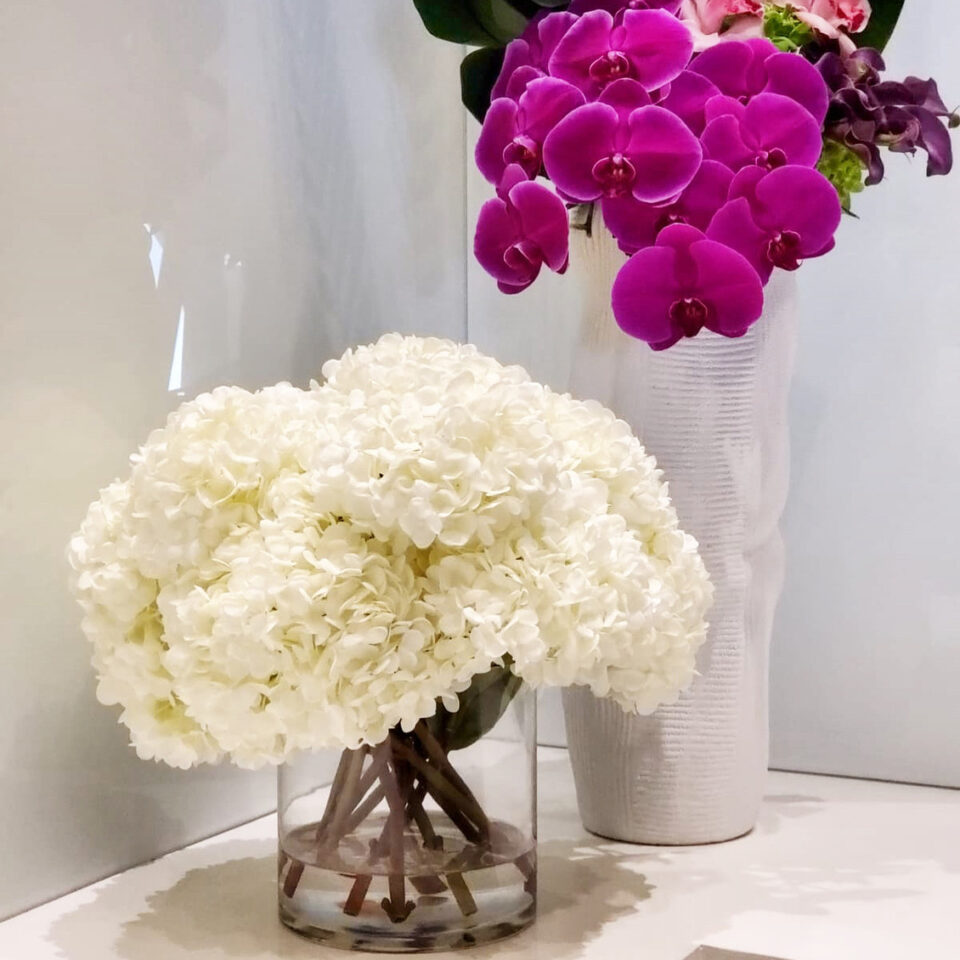 White Hydrangea Bouquet in clear glass cylinder vase - CFA Design Group